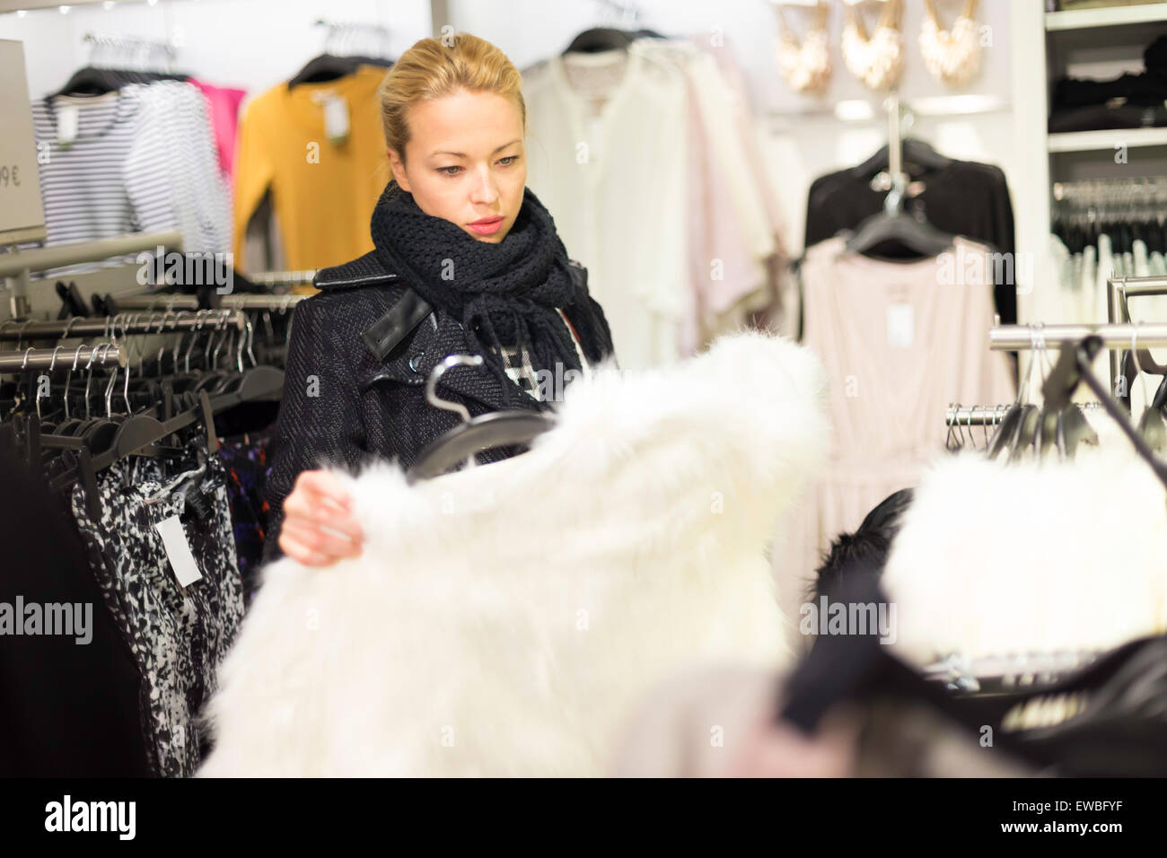 Beautiful woman shopping in clothing store Stock Photo - Alamy