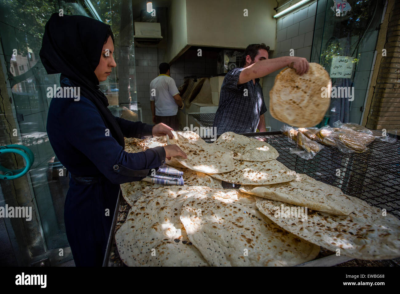 Iranian woman buying bread for the breakfast at local bakery, Isfahan ...