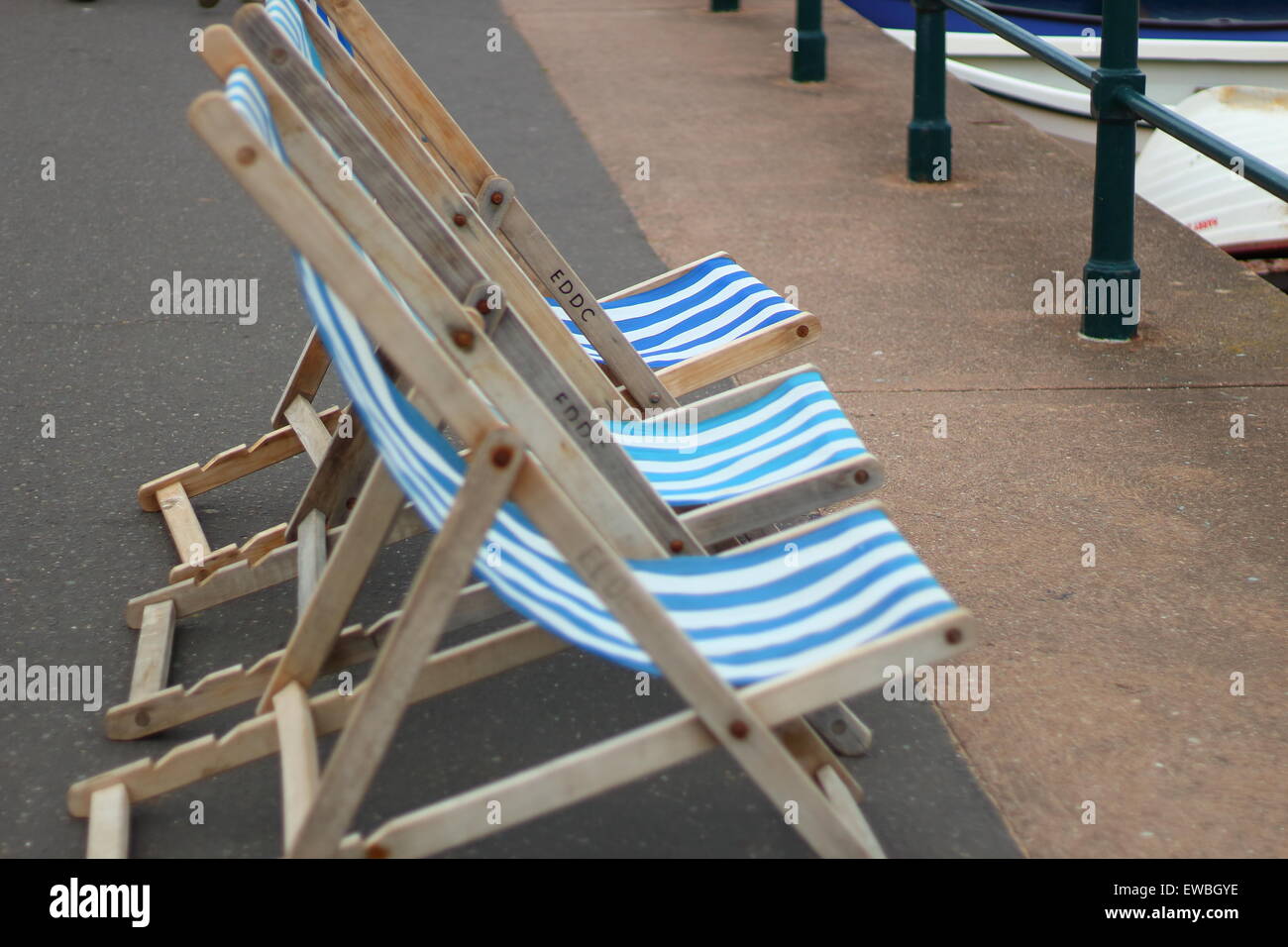 Three lonely, empty deck chairs waiting to be sat on and used. Looking ...