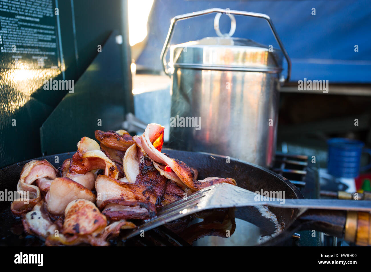 Bacon cooked on a gas camping stove, Australia Stock Photo - Alamy
