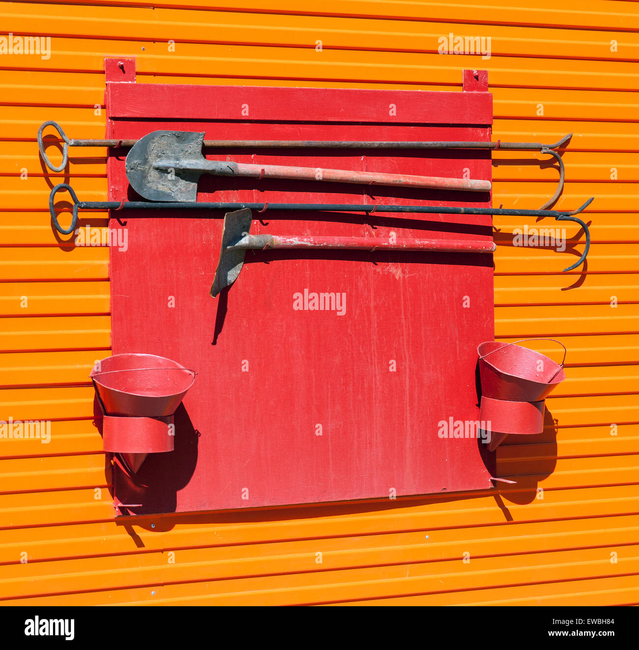 Firefighter shield with fire extinguishing tools Stock Photo - Alamy