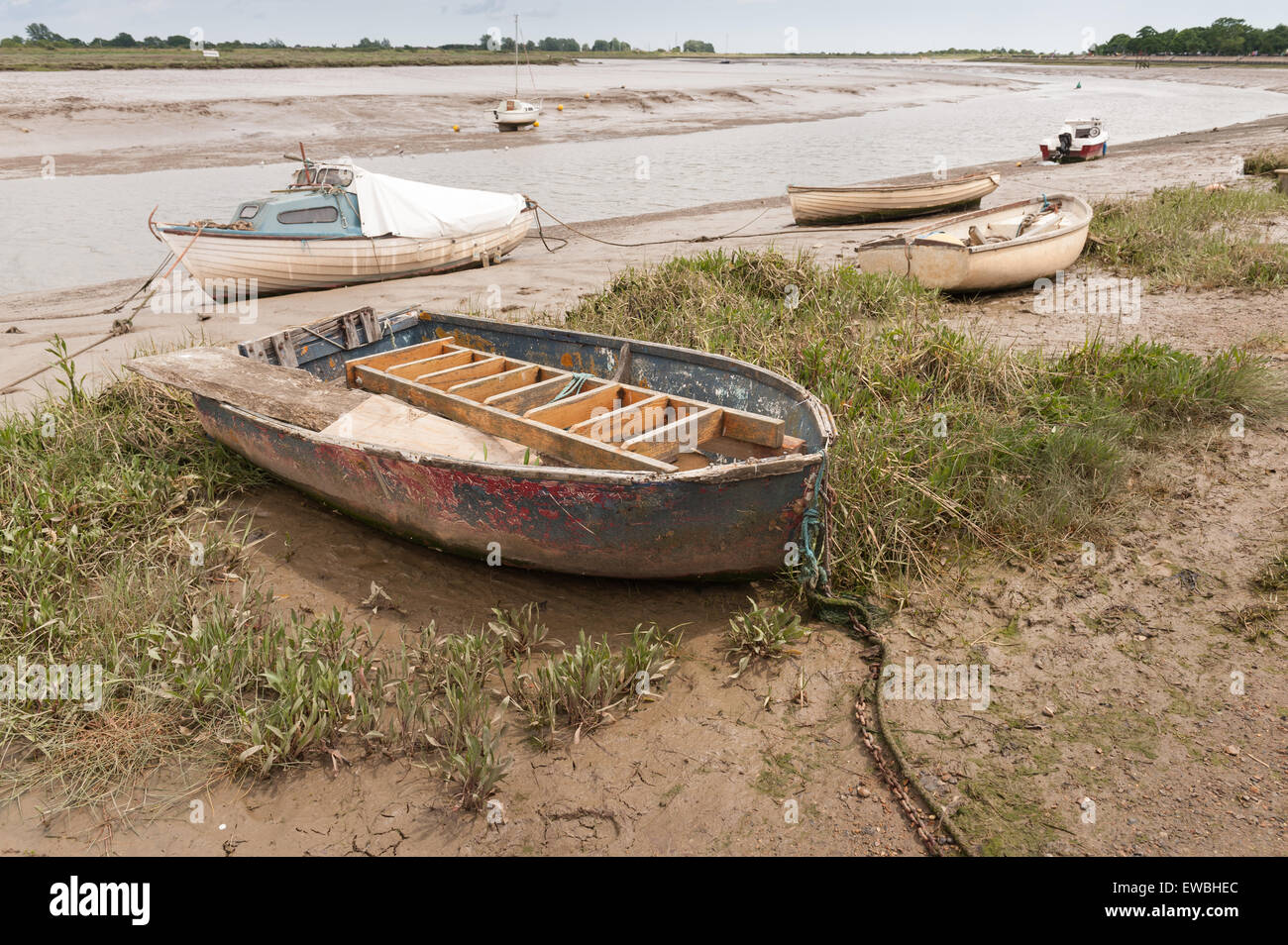 marooned sailing boat boats raised up on silty mud and sand at low tide ...