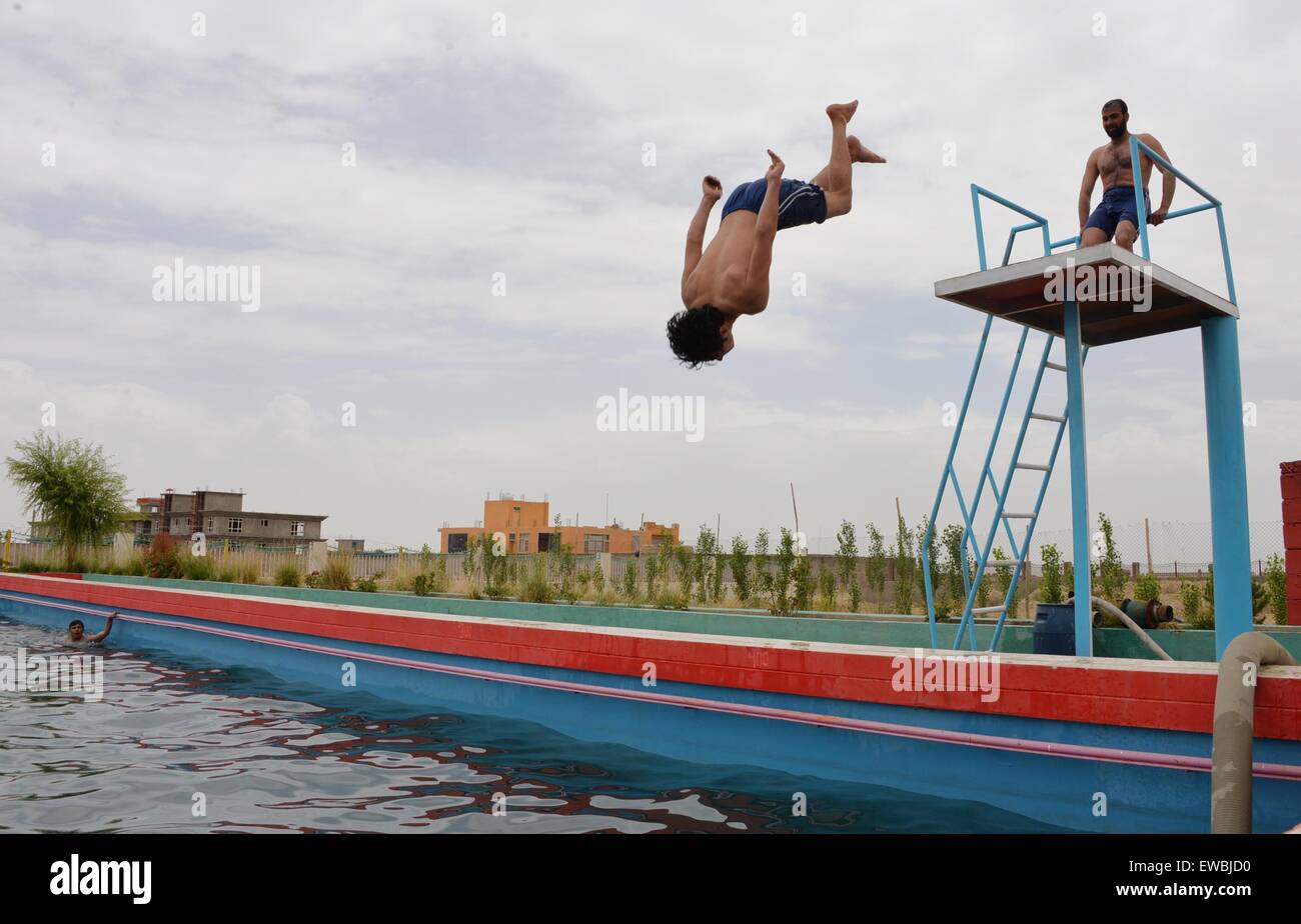 Ghazni, Afghanistan. 22nd June, 2015. An Afghan man jumps into a ...
