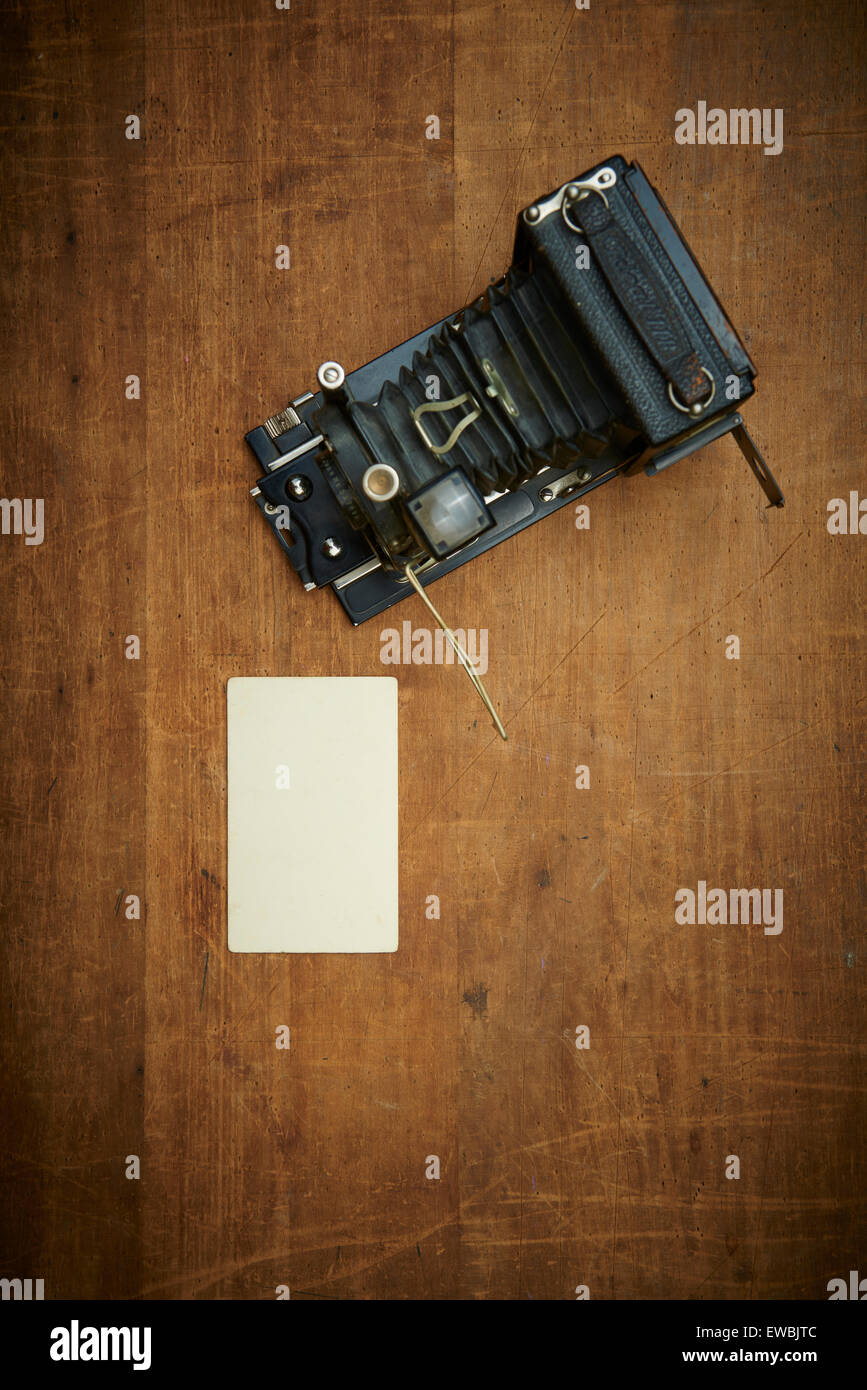 Vintage old retro film camera and old empty paper frame photos on ...