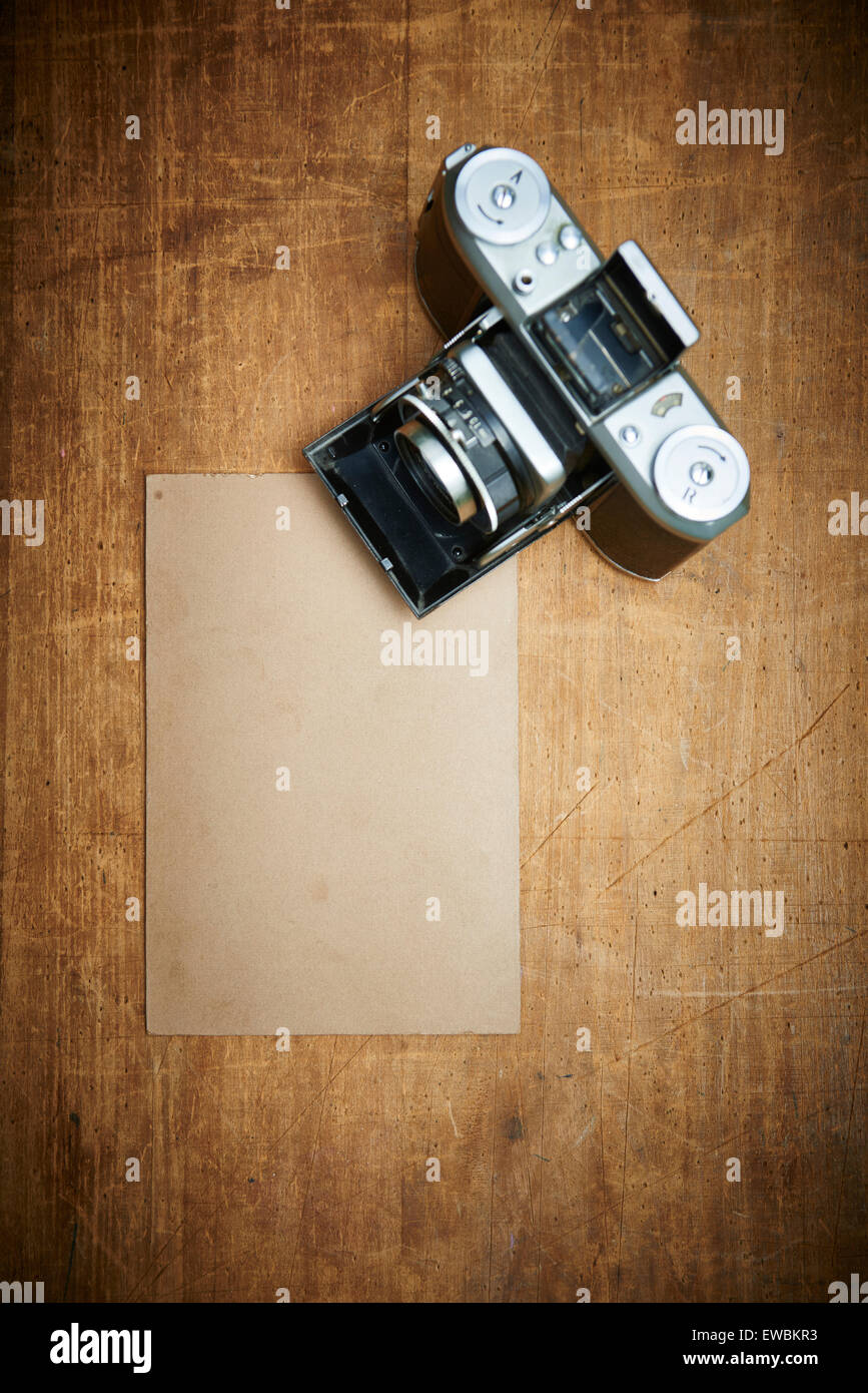 Vintage old retro film camera and old empty paper frame photos on ...