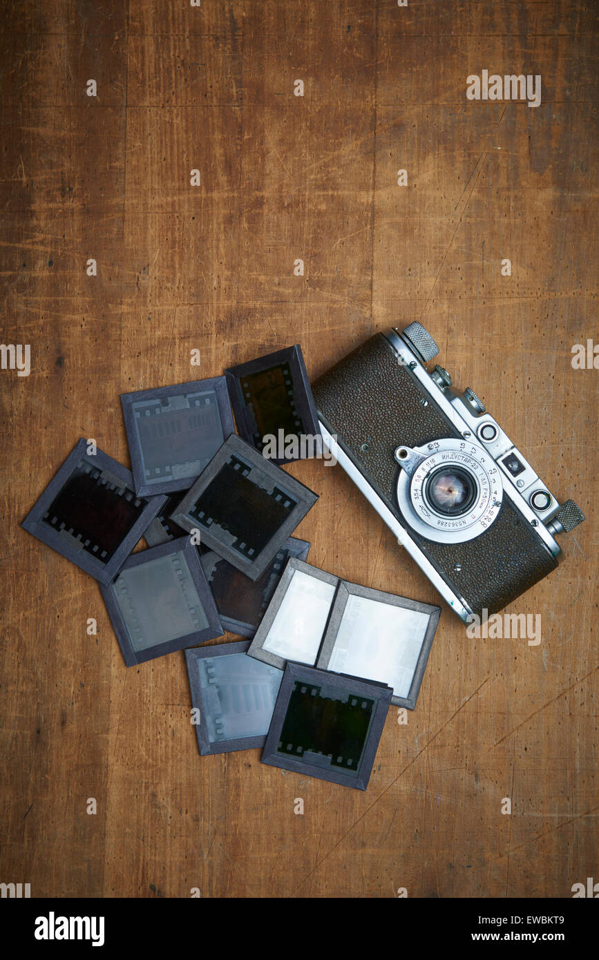 Vintage old retro film camera and old empty paper frame photos on ...