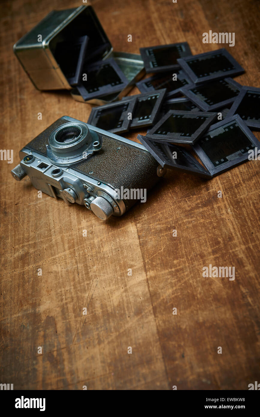 Vintage old retro film camera and old empty paper frame photos on ...