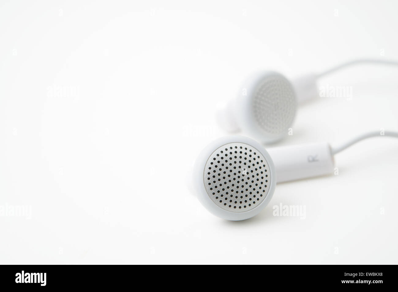 earbuds on white background Stock Photo - Alamy