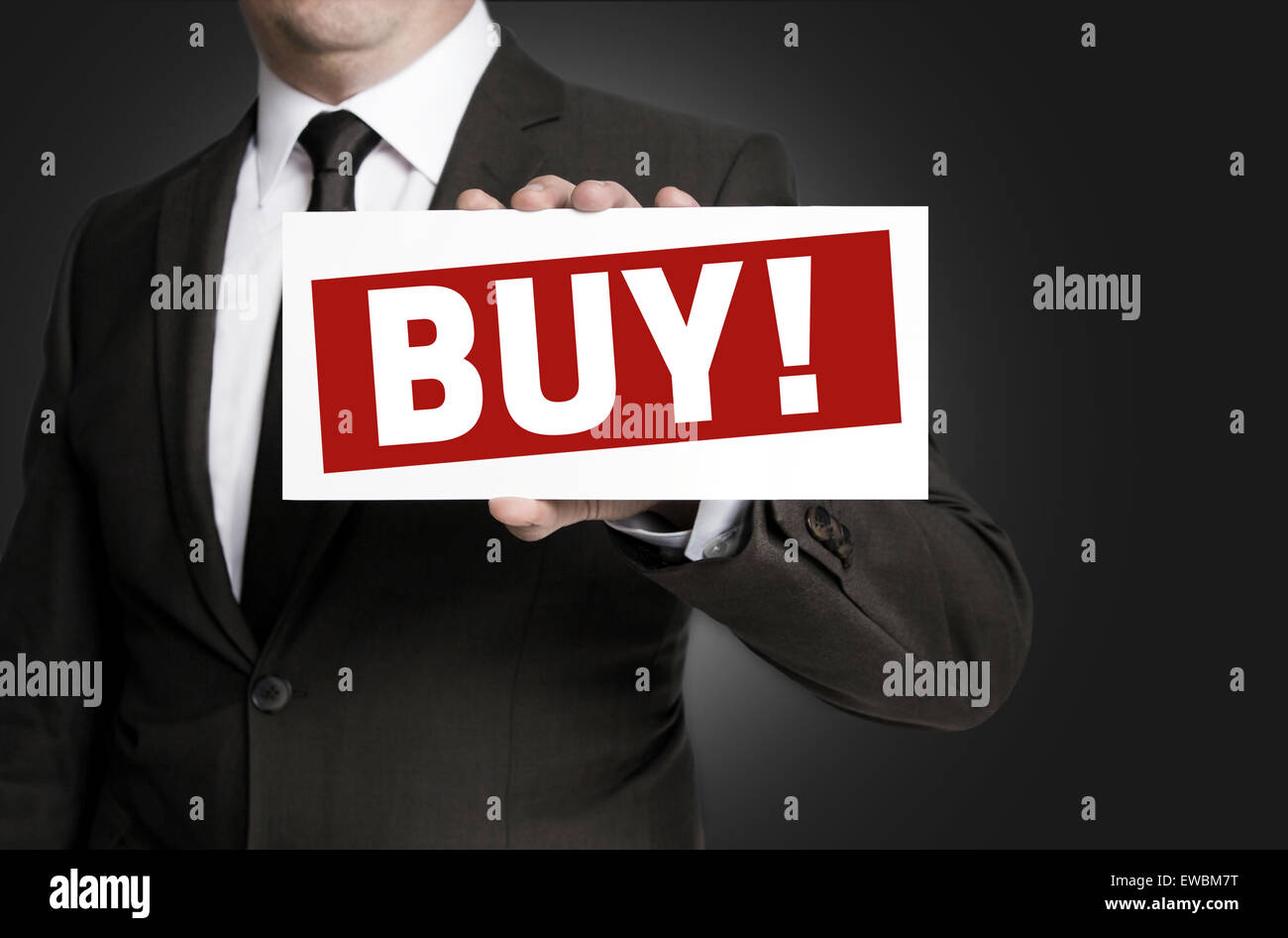 Buy sign is held by businessman Stock Photo - Alamy