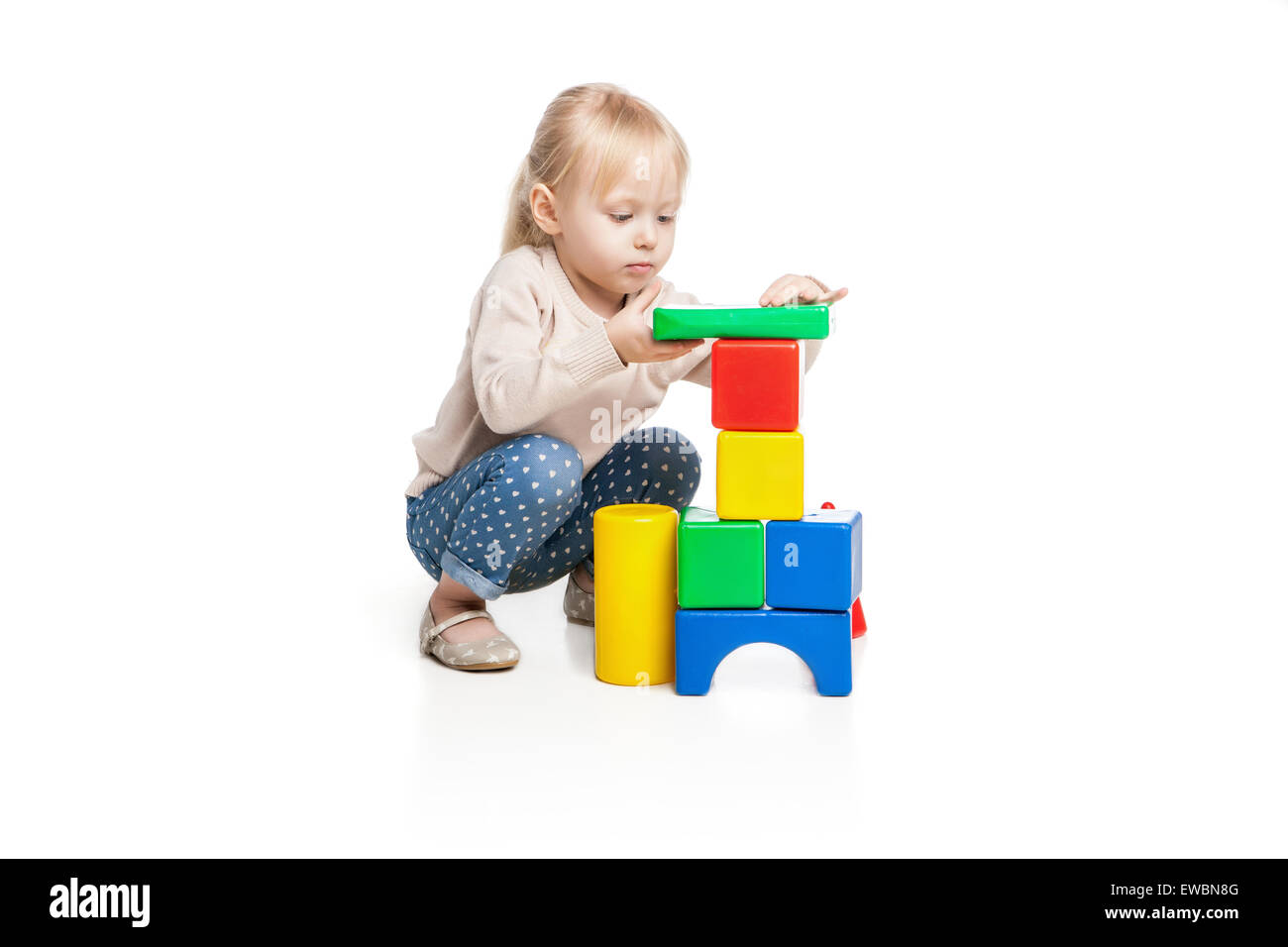 Baby girl building from toy blocks Stock Photo - Alamy