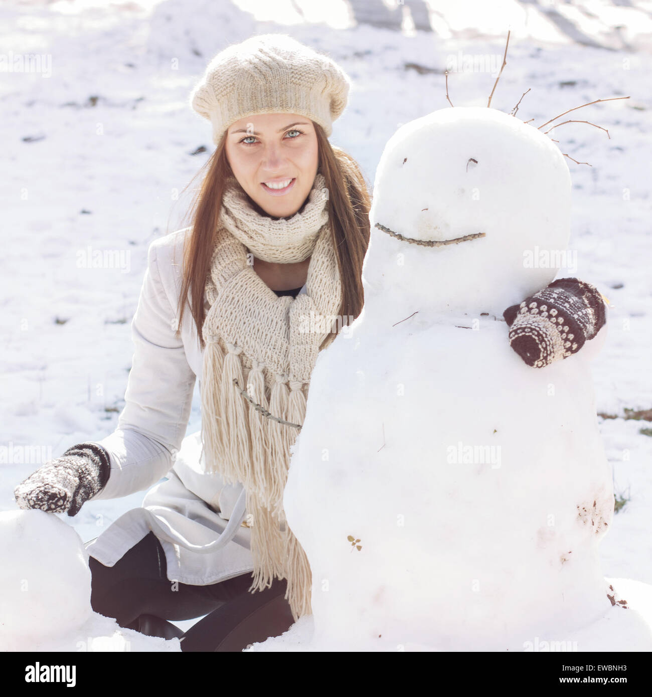 Winter Happy Woman Embracing Snowman in the park. Caucasian female ...
