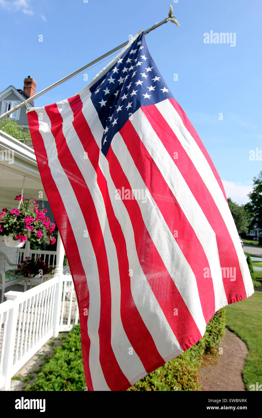An American flag flaps in the breeze outside a Long Island home Stock ...