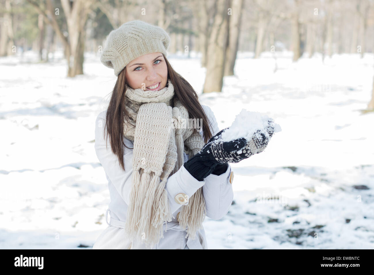 Happy Beautiful Winter Woman playing with snow in the park. Caucasian ...