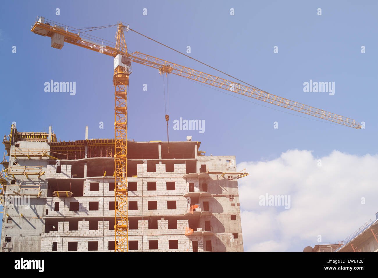 Building crane on construction site against blue sky Stock Photo - Alamy
