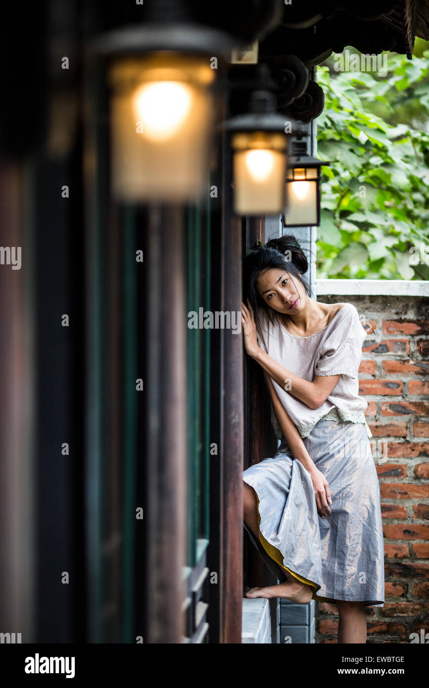 A young Vietnamese woman outside of a rural home in Hanoi, Vietnam ...