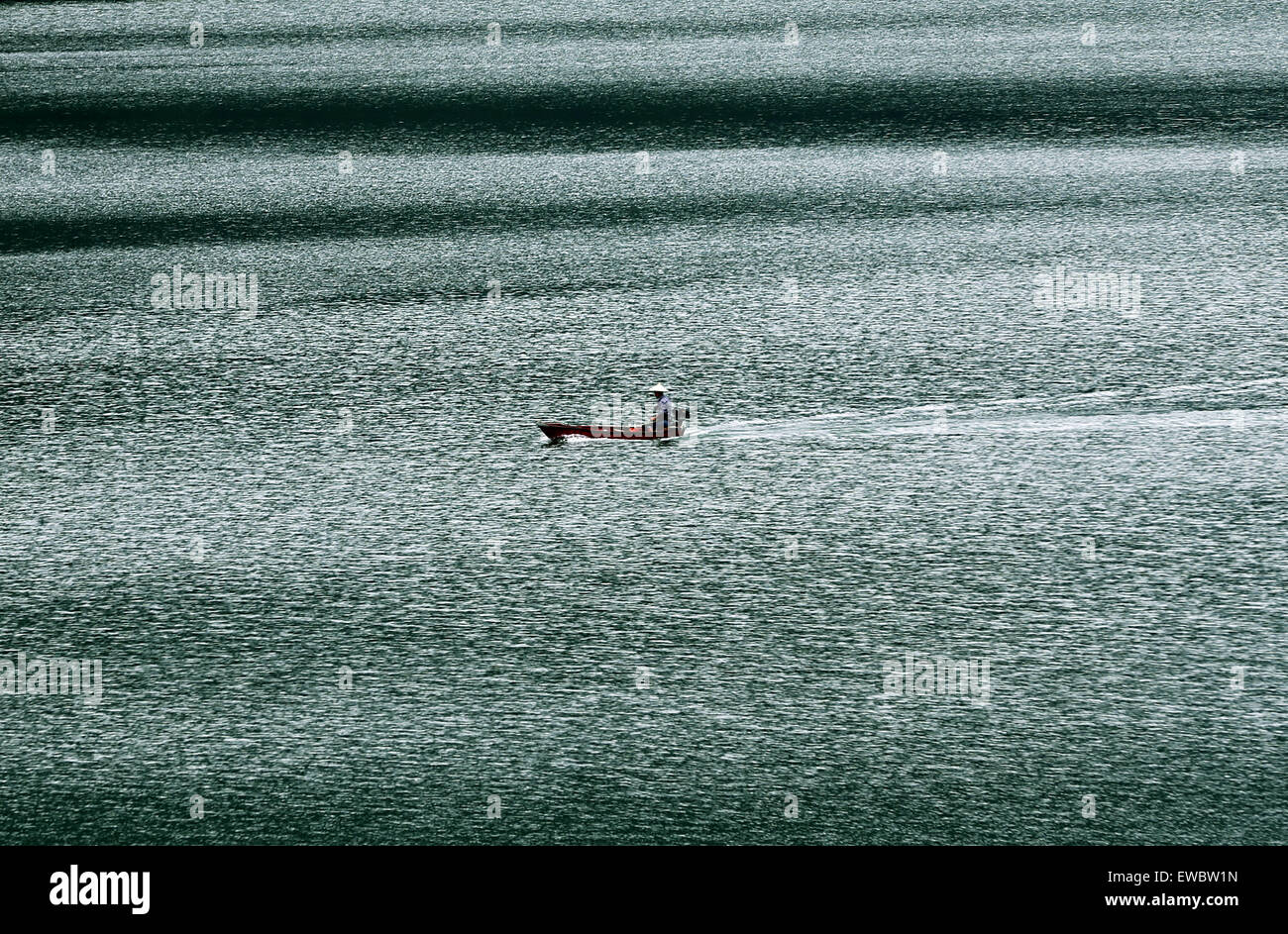 Chongqing, China. 22nd June, 2015. A villager goes fishing on a boat on ...
