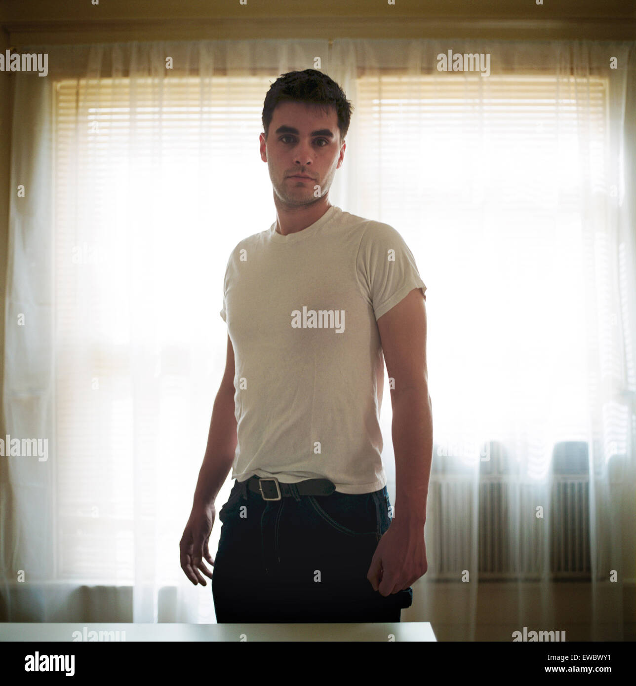 A young man stands for a portrait in his home Stock Photo - Alamy
