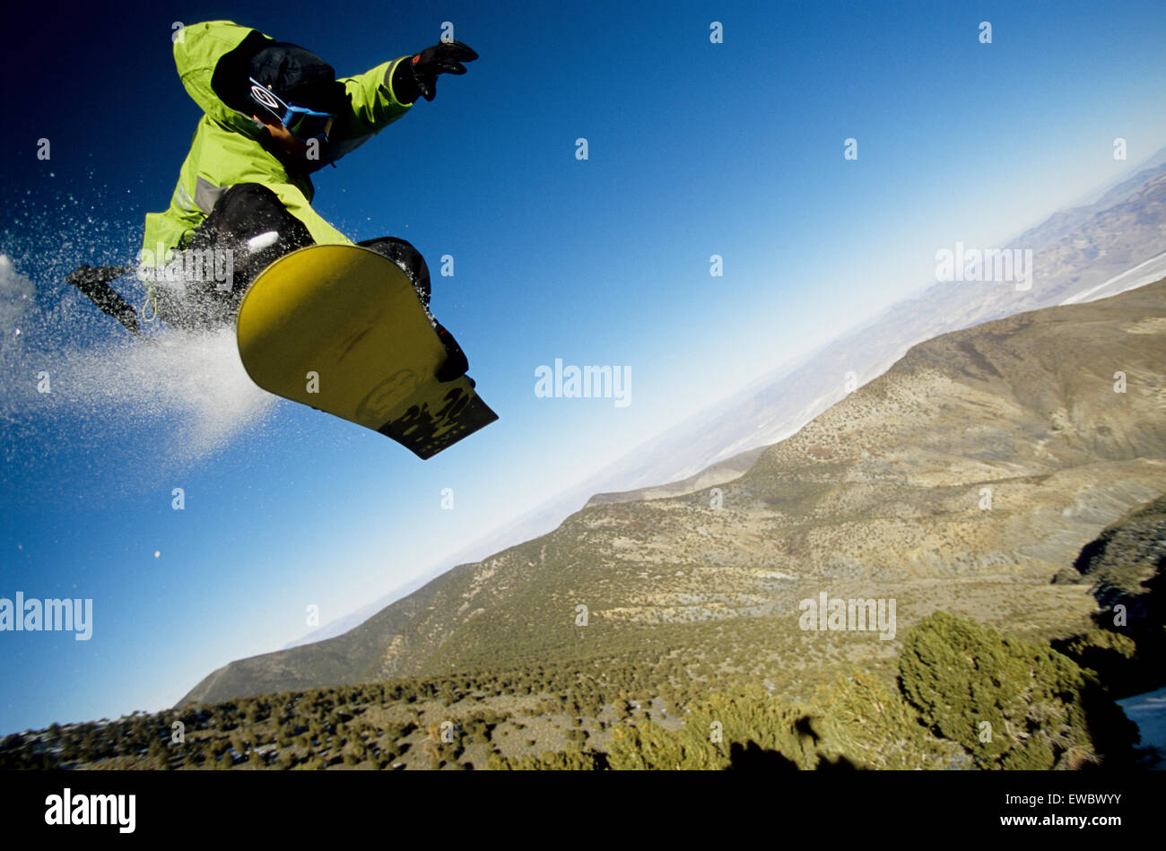 A snowboarder dropping off a cliff in Death Valley, California Stock ...