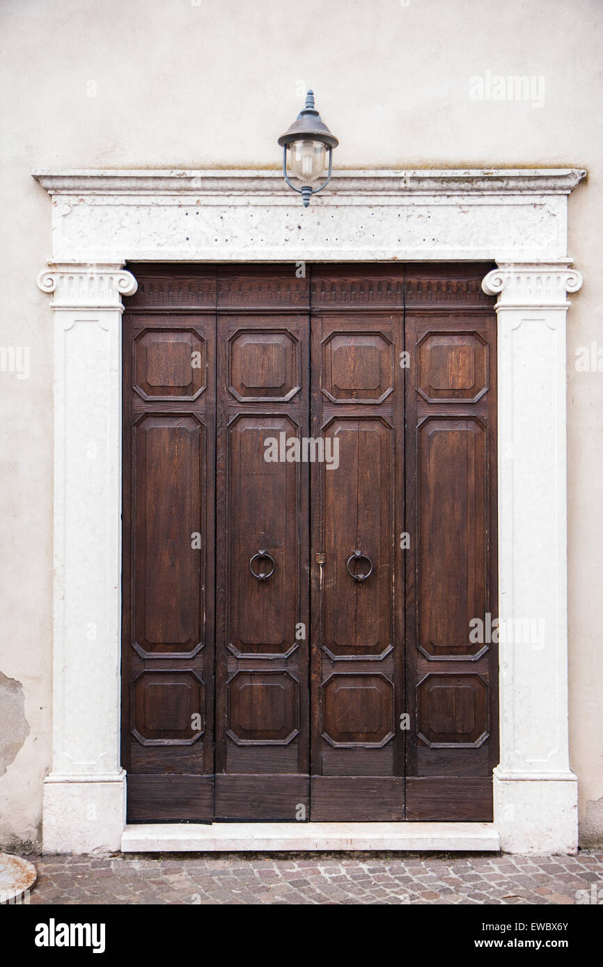 old wooden door with marble columns and lamp Stock Photo - Alamy