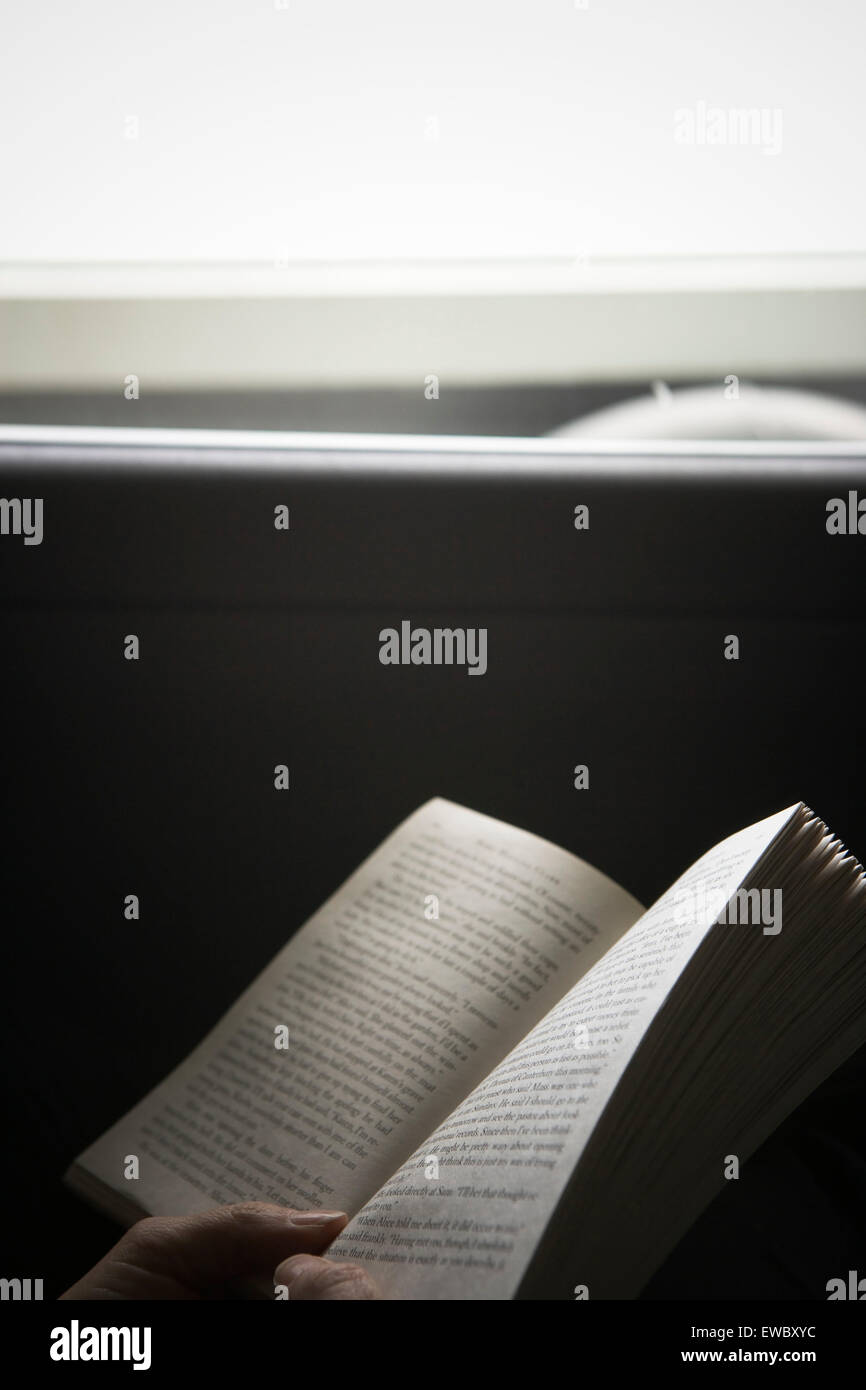 A hand holding a open book Stock Photo - Alamy