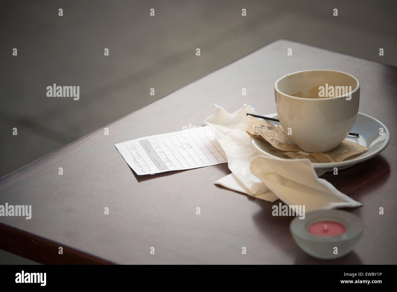 A finished cup of coffee on outdoor cafe table Stock Photo - Alamy