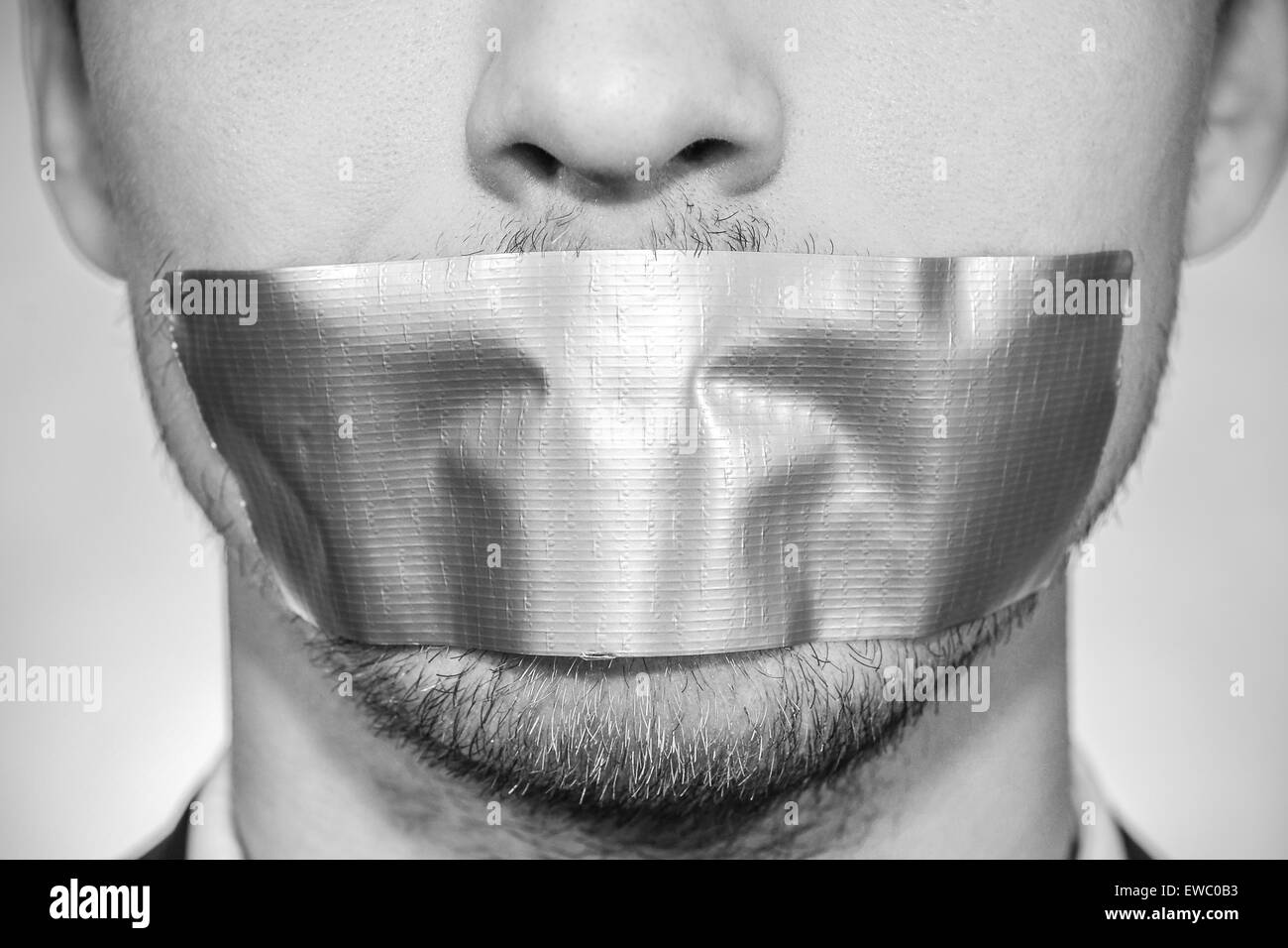 Photo of a young man with sellotape covering his mouth Stock Photo - Alamy