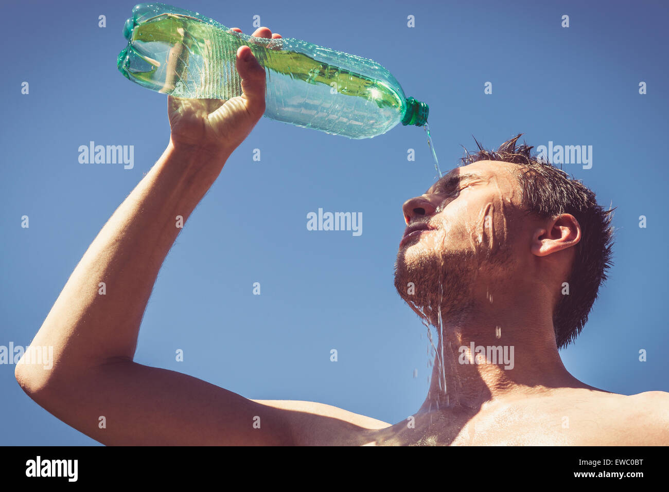 Photo of a man who's face is covered with water. Beautiful sky in the ...