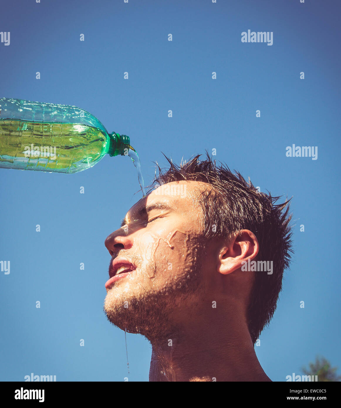 Photo of a man who's face is covered with water. Beautiful sky in the ...