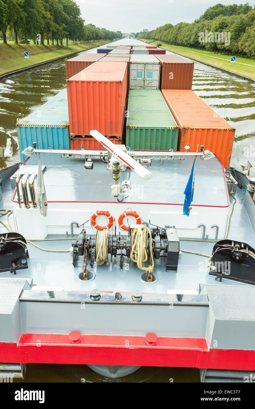 Ship carrying metal cargo containers on river Stock Photo - Alamy