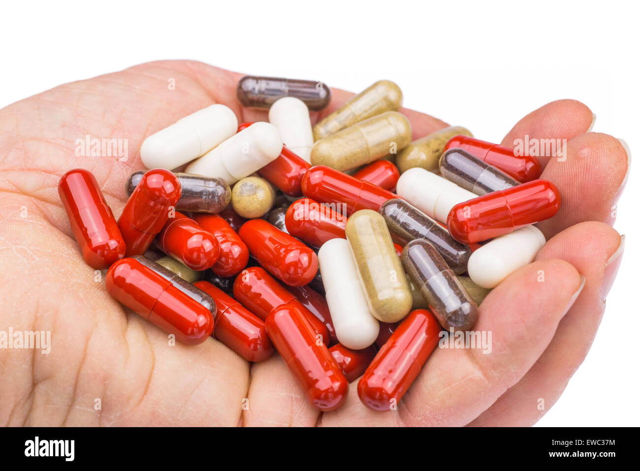 Hand holding medical capsules as medicines isolated on white background ...