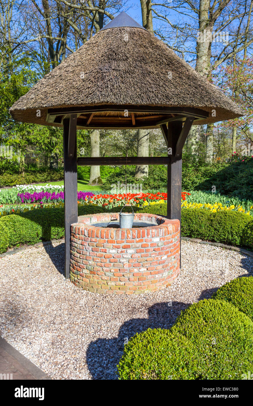 New brick waterwell with bucket in park in Netherlands Stock Photo - Alamy