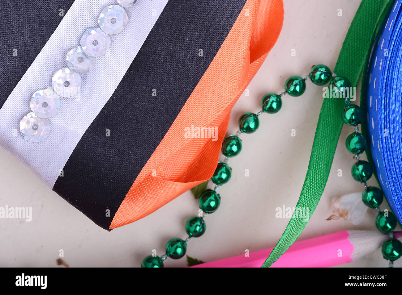 Office table with ribbons, pencils and pearls Stock Photo - Alamy