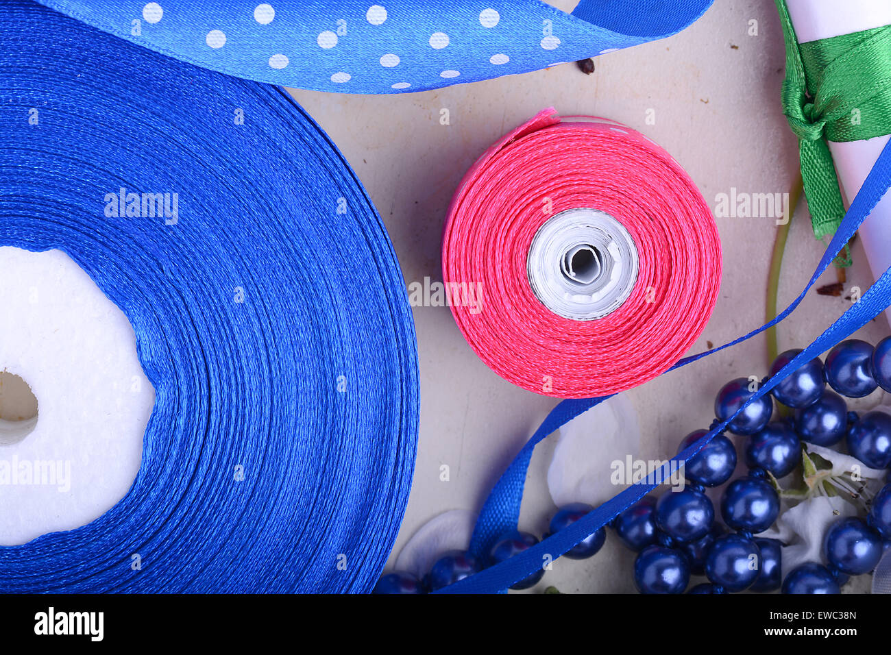 Office table with flower, ribbons, pencils, pearls Stock Photo - Alamy