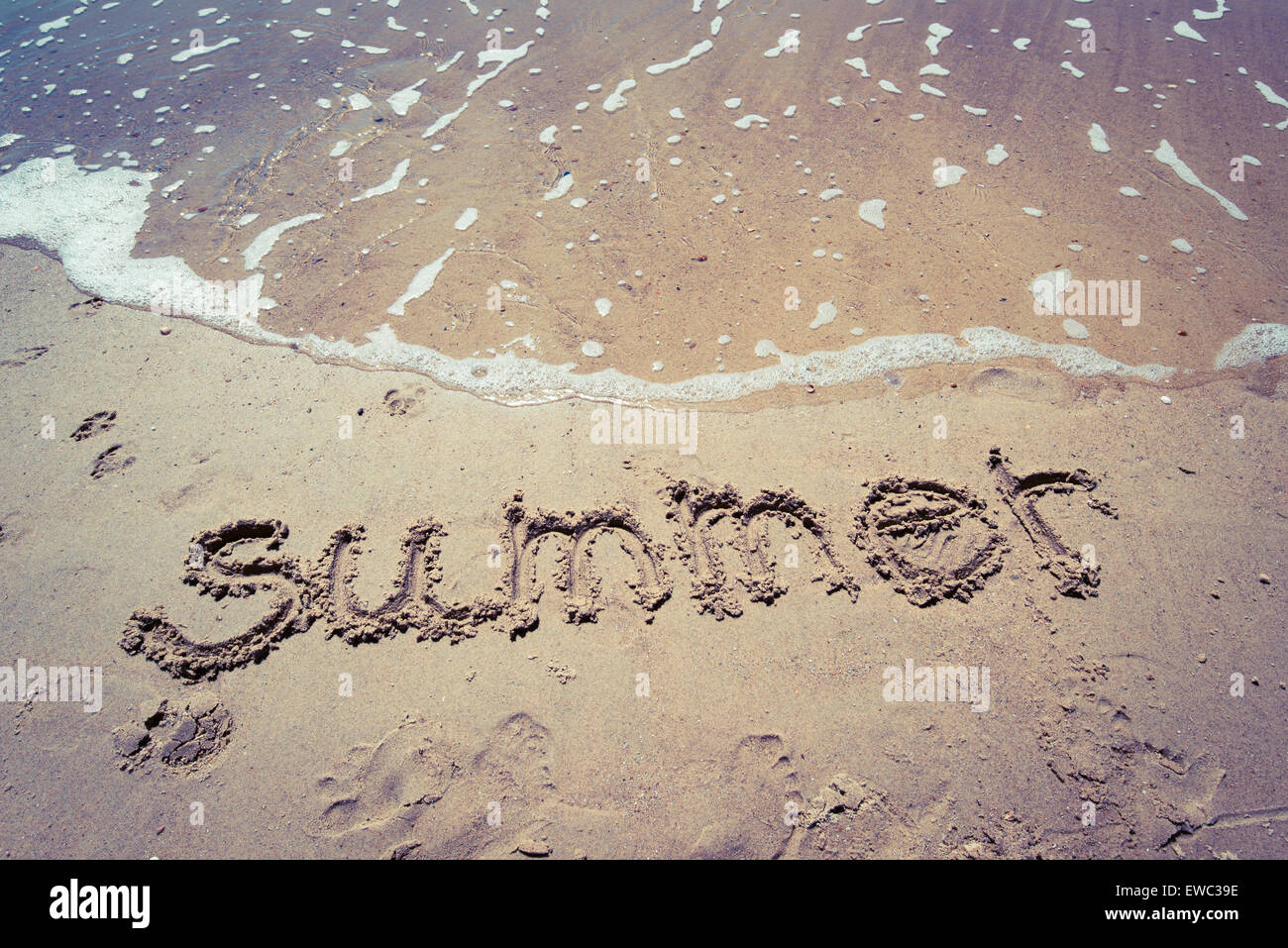 text an drawing on the beach in the sand Stock Photo - Alamy