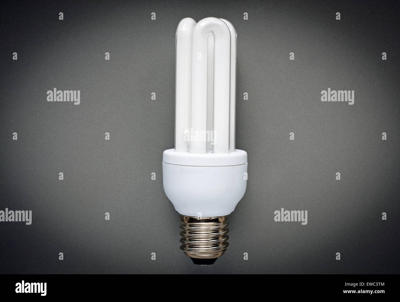 Energy saving bulb on grey background Stock Photo - Alamy