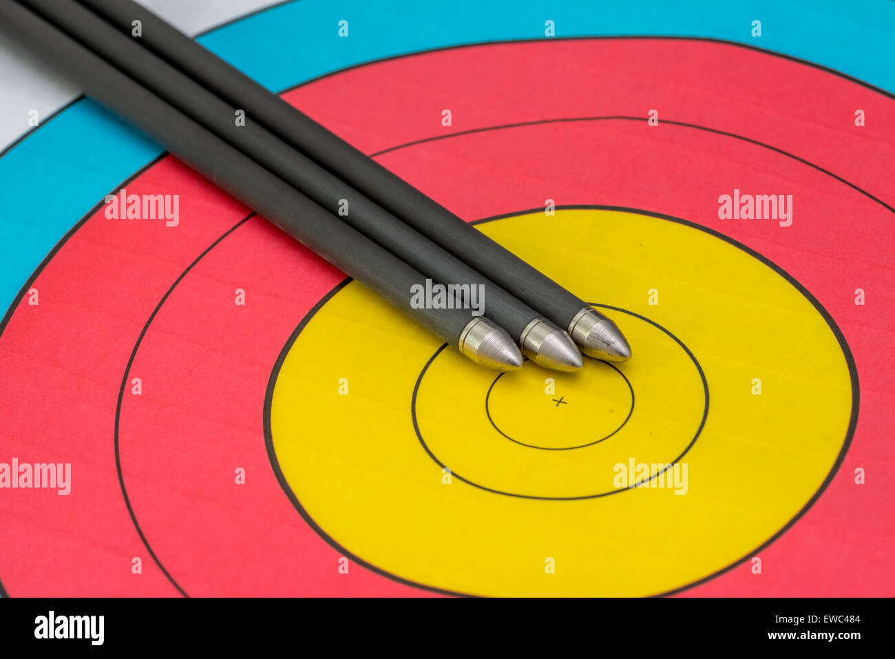 Three arrows sitting on bullseye of a paper target Stock Photo - Alamy