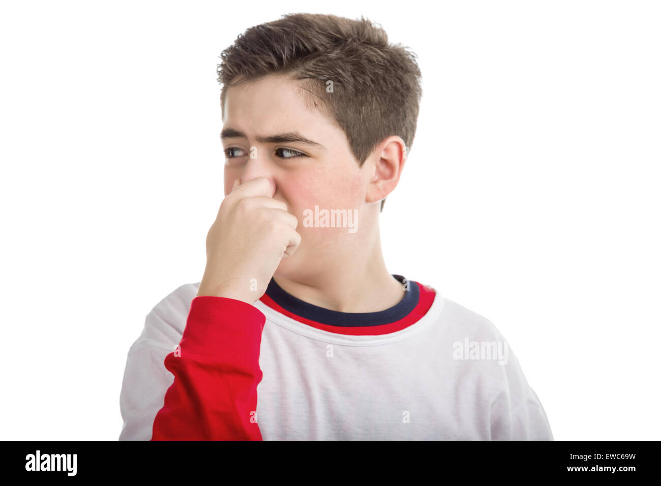 A cute Caucasian smooth-skinned boy is plugging his nose because of bad ...