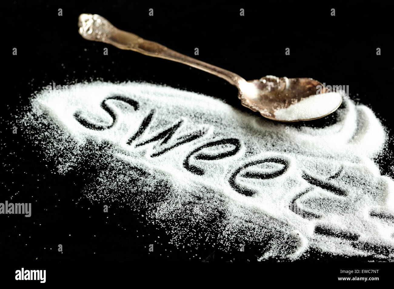 Word "sweet" written in sugar on a black background Stock Photo - Alamy