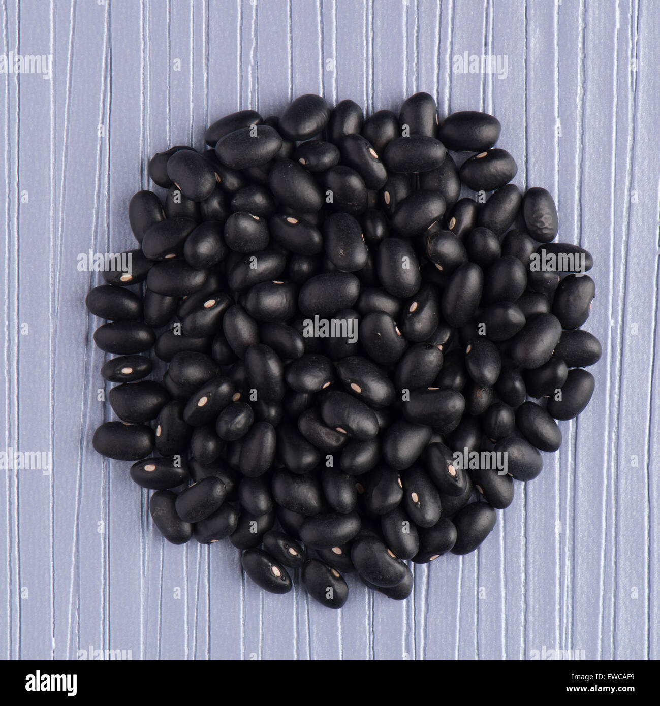 Circle of red beans on purple beige background Stock Photo - Alamy