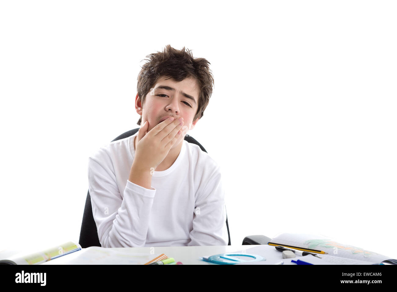 Tired Caucasian smooth-skinned boy sits in front of homework wearing a ...