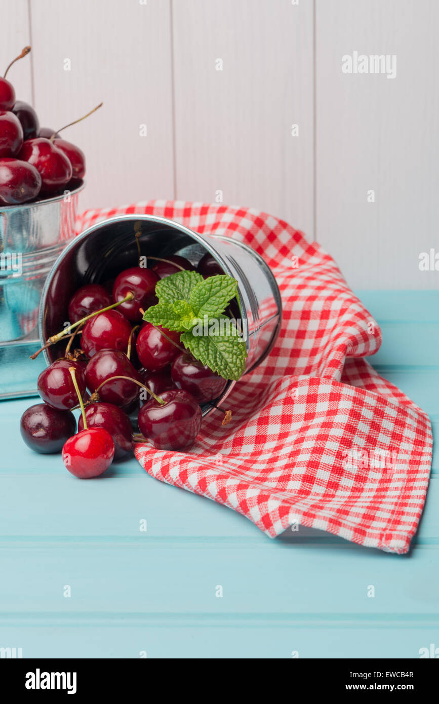 Ripe red cherries in blue wooden table background Stock Photo - Alamy