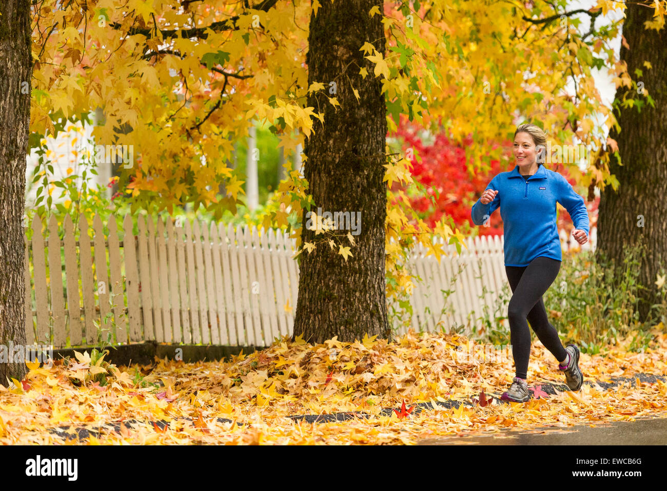 Young woman running in fall Stock Photo - Alamy