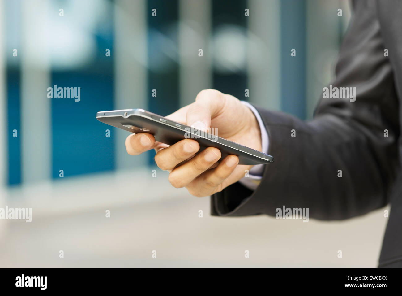 Closeup of businessman typing note on mobile phone. The man writes on ...
