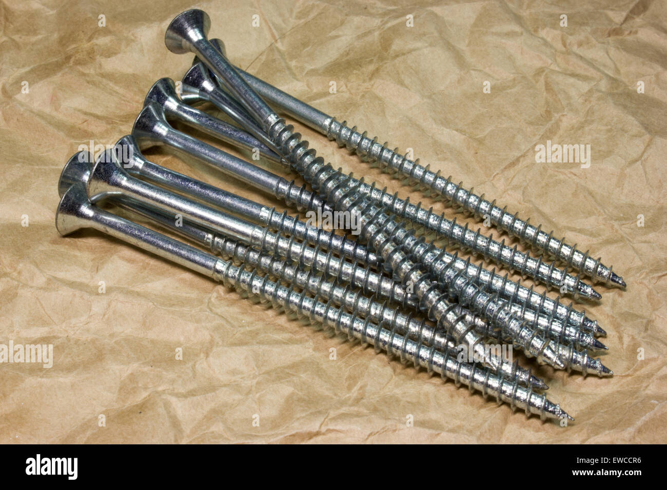 Screws on vintage paper Stock Photo - Alamy