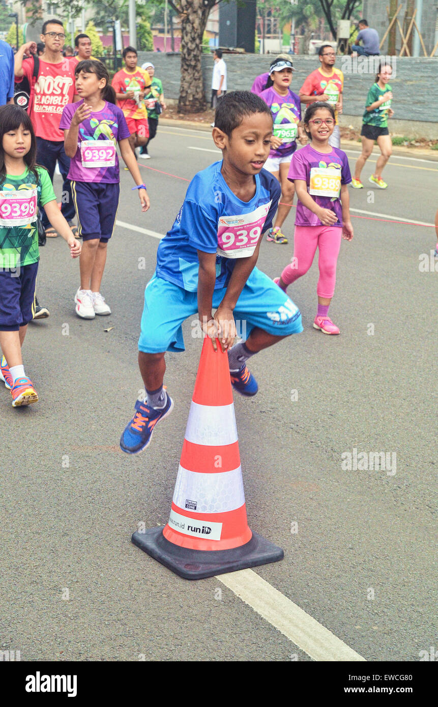 Boy jumping over a traffic cone Stock Photo - Alamy