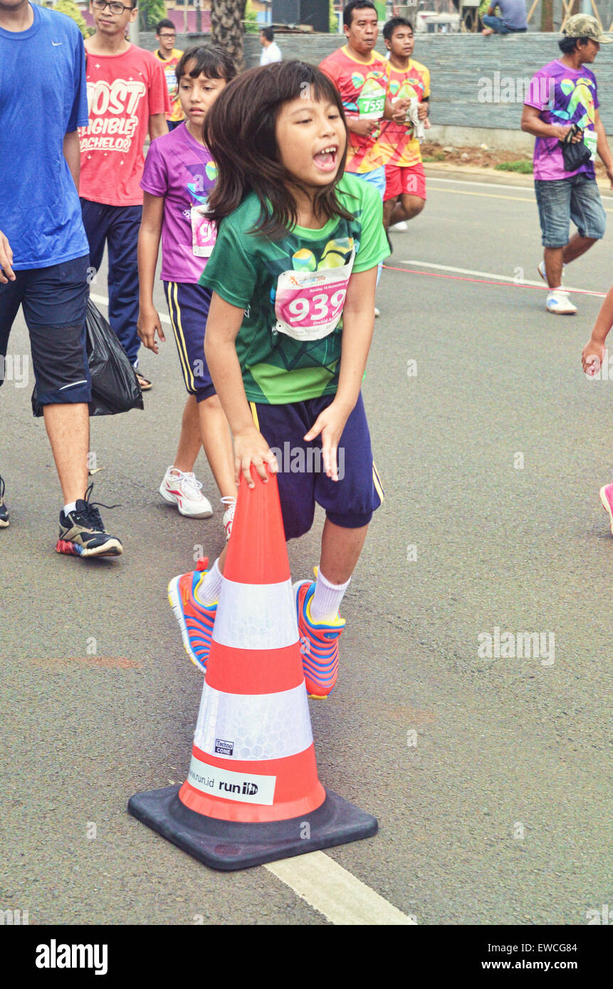 Little girl jumping over a traffic cone Stock Photo - Alamy