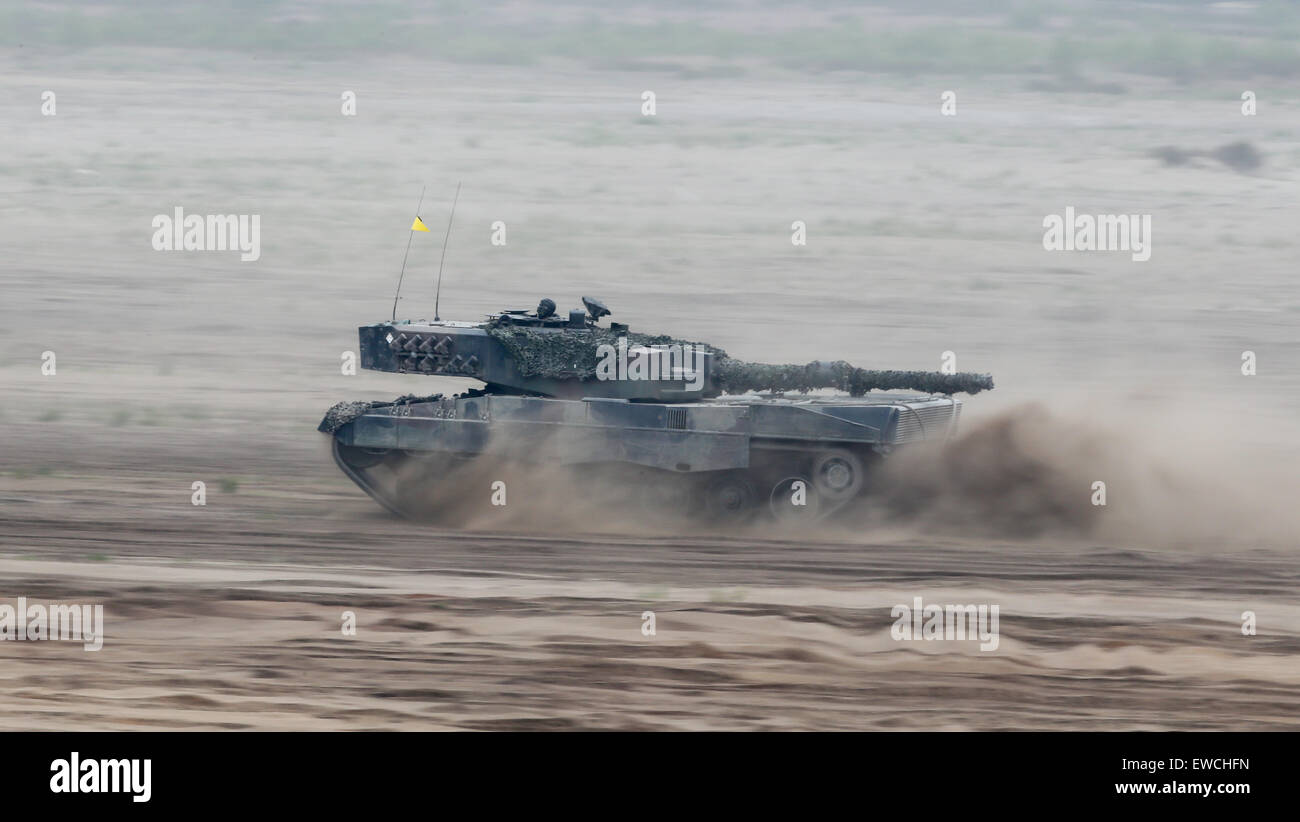 A Leopard 2 tank makes its way through a military training ground ...