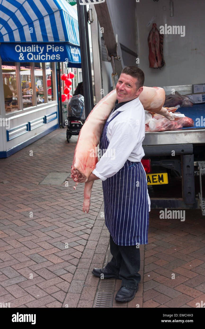 Butcher off loading a pig carcass for his shop Stock Photo - Alamy