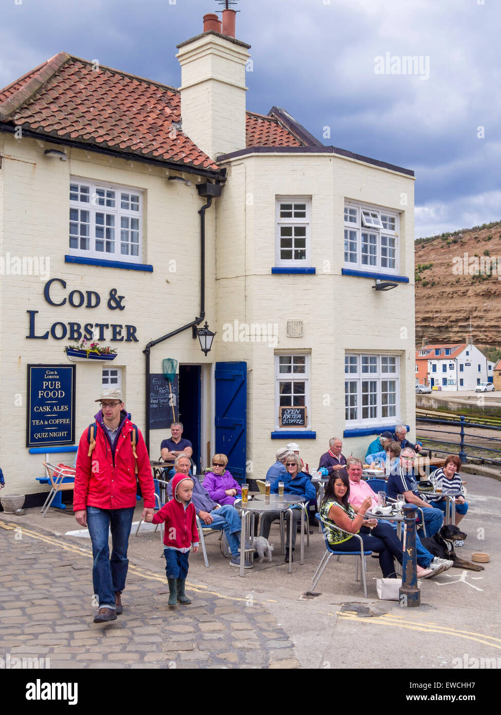 Outside the Cod and Lobster pub on the harbour front at Staithes North ...