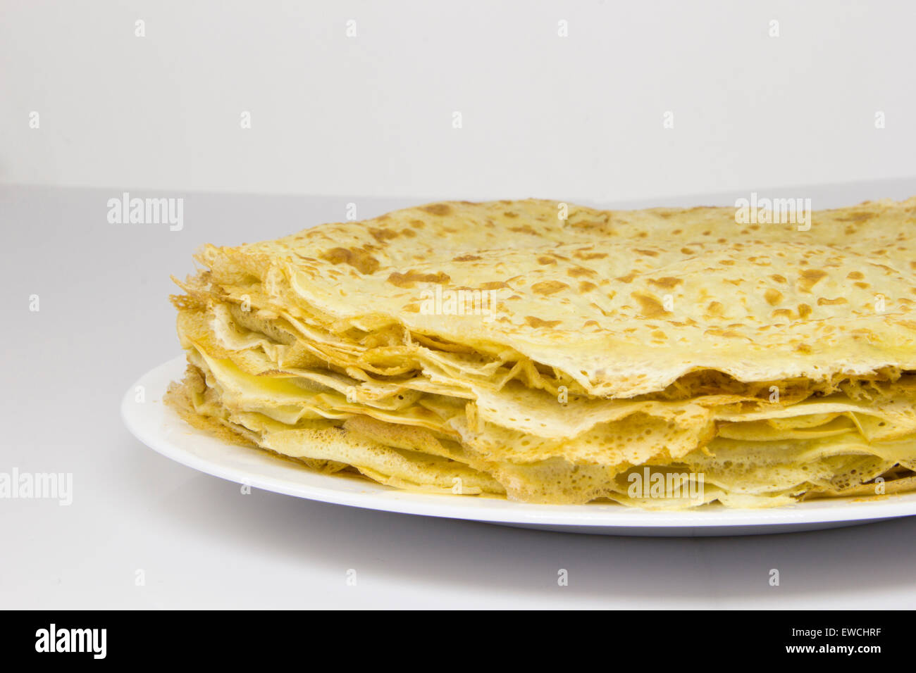Stack of crepes (pancakes) on white plate closeup Stock Photo - Alamy
